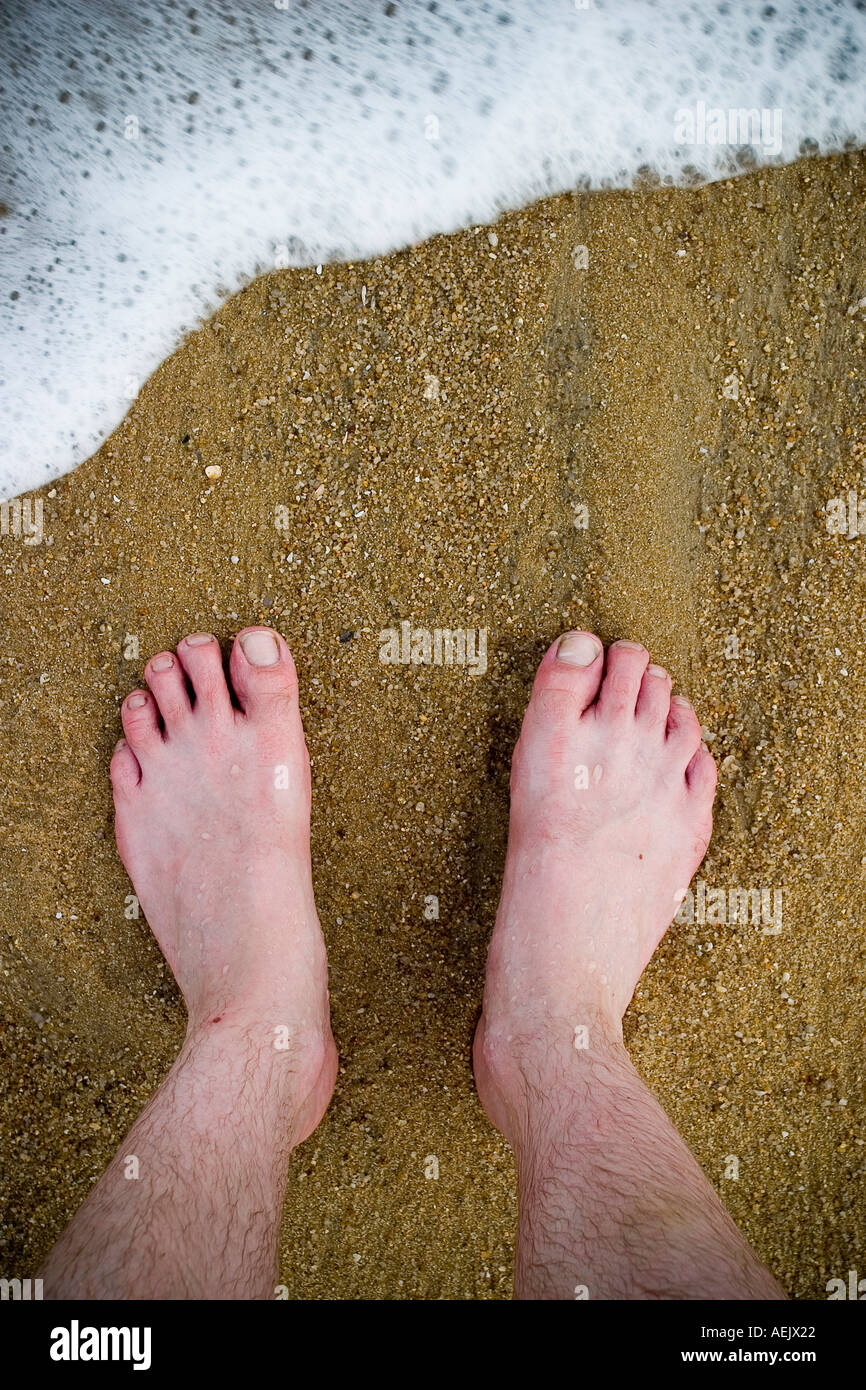 Feet in the sand Stock Photo - Alamy