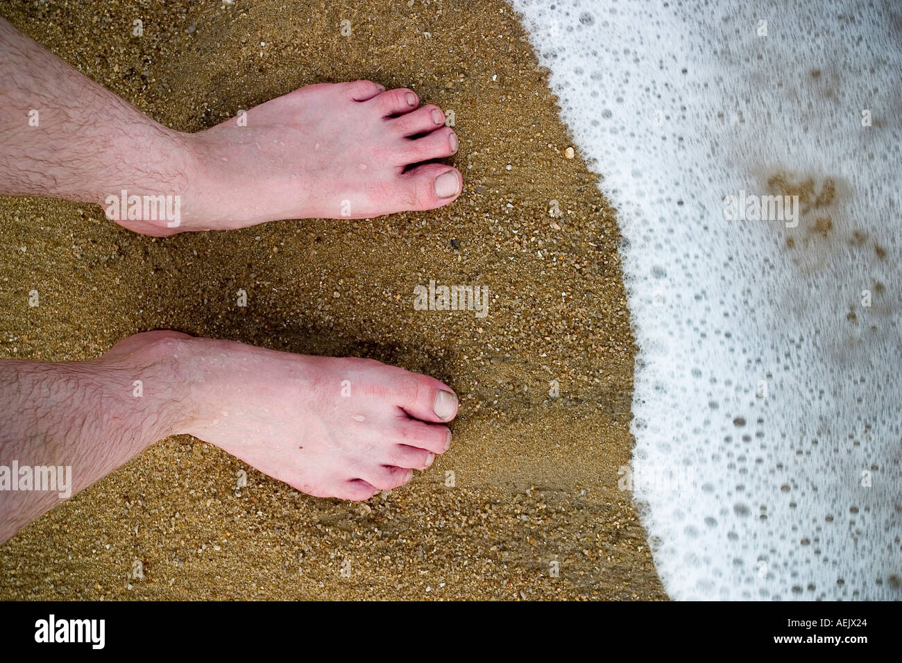 Feet in the sand Stock Photo - Alamy