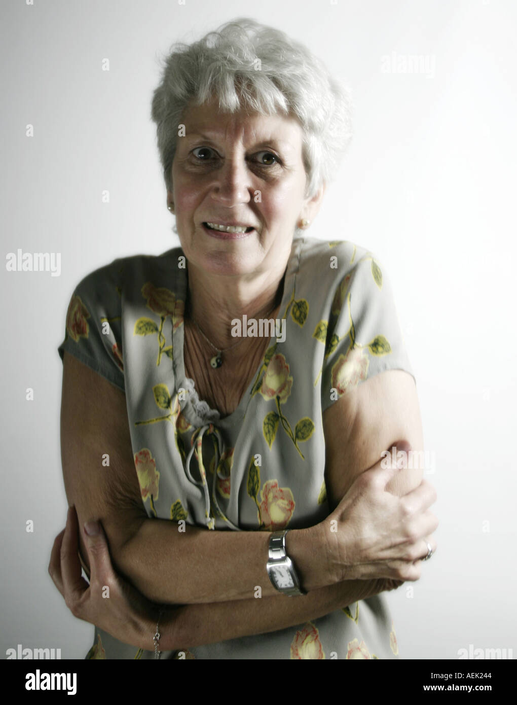 Woman aged sixty looking cold Stock Photo - Alamy