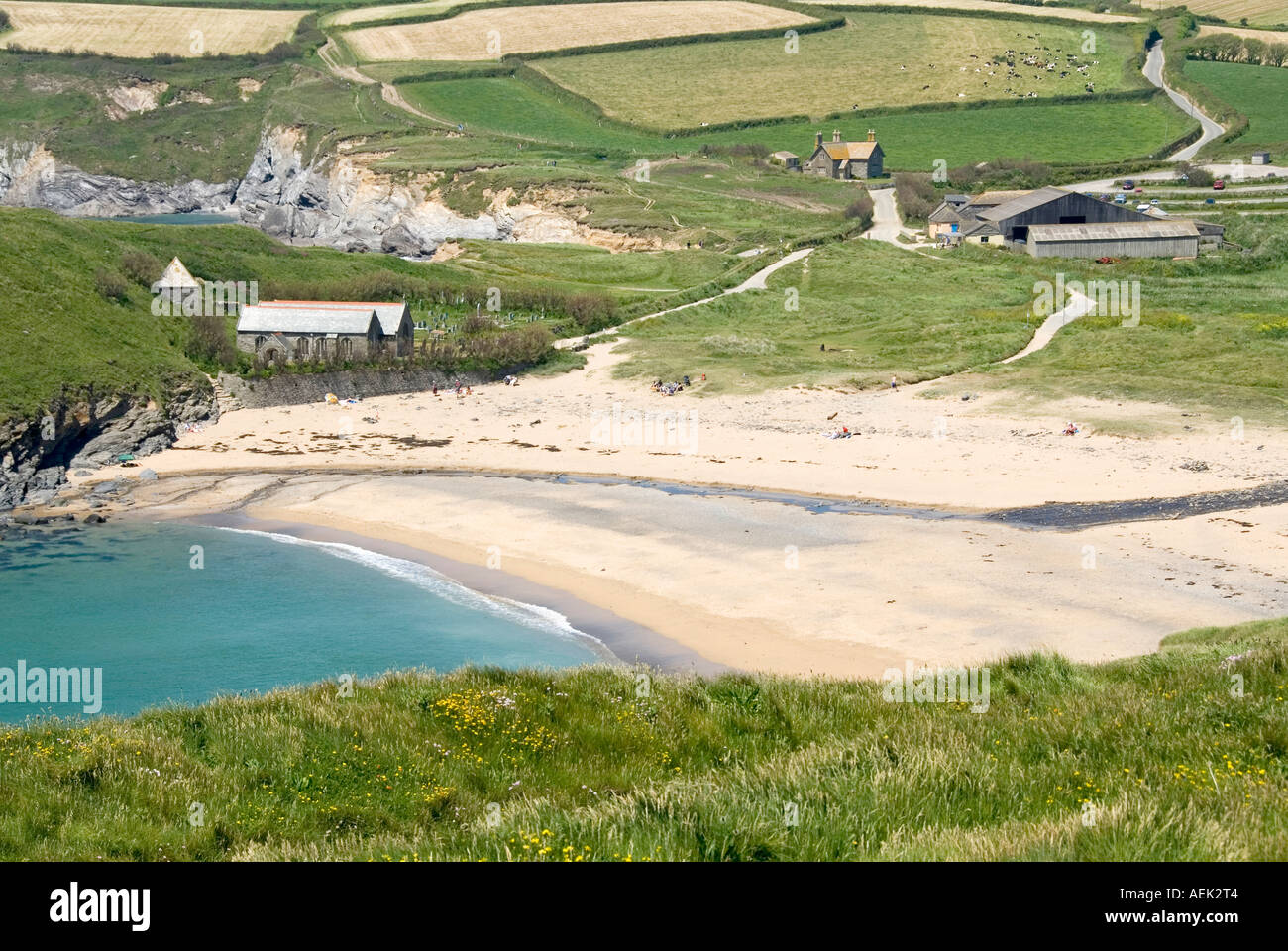 Lizard Peninsula farm & hilly farming landscape beyond sandy beach at ...