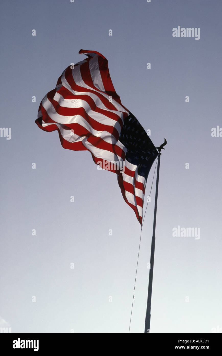 American flag blowing in the wind from flagpole Stock Photo - Alamy