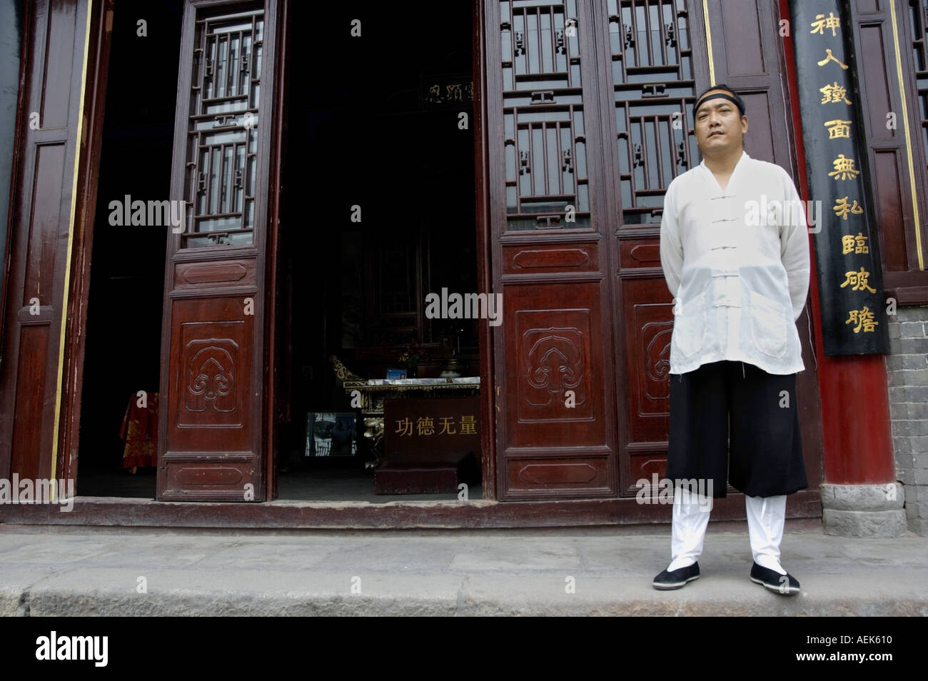 Taoist priest standing outside the Temple of the Eight Immortals (Ba ...