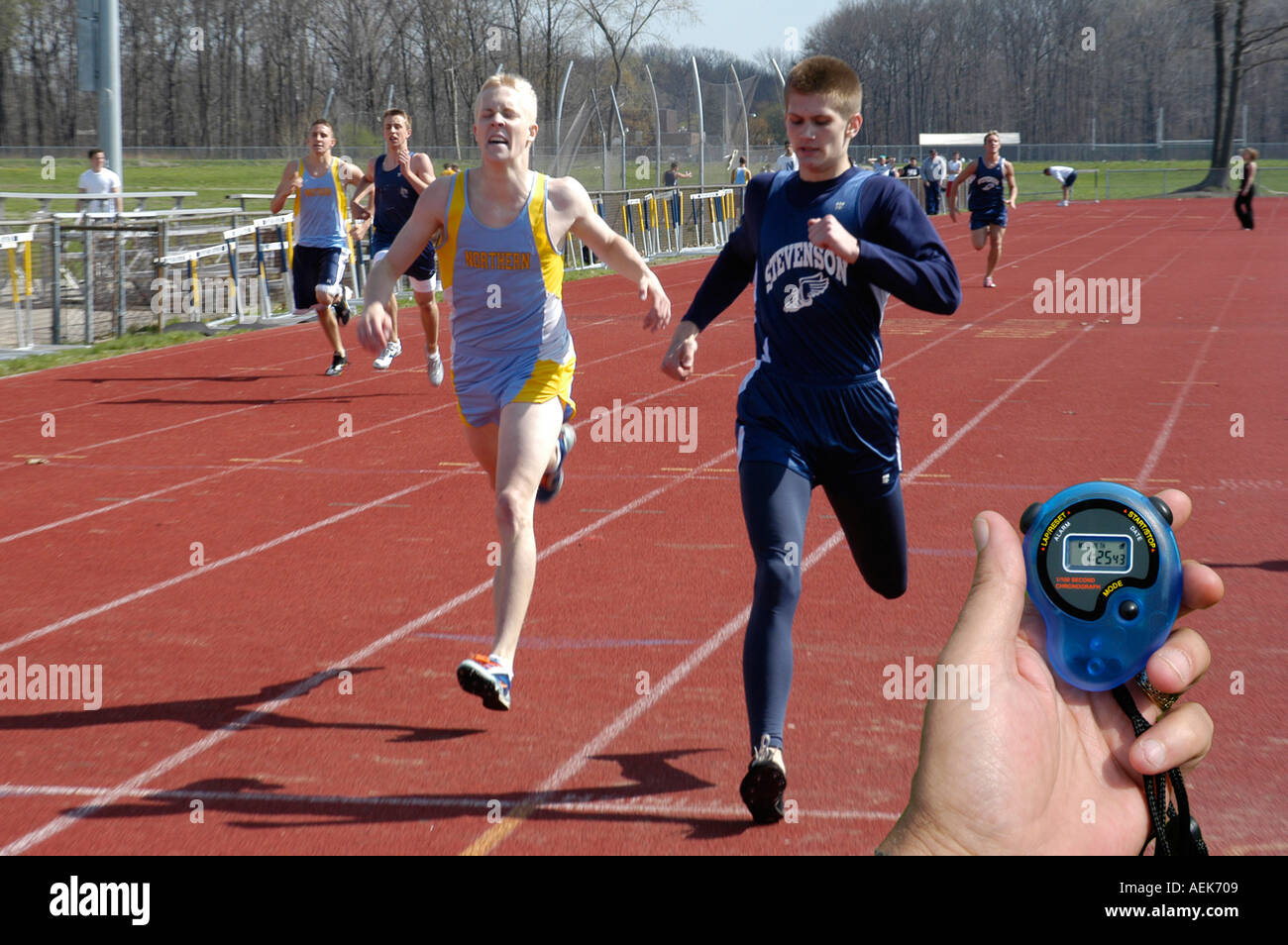 a hand held digital stop watch is used to time runners during a track ...