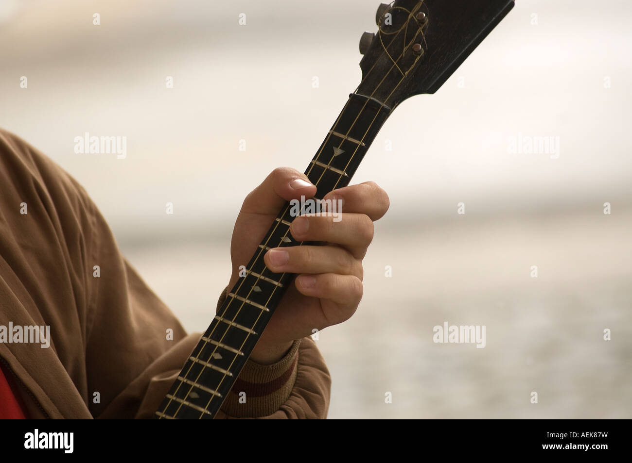 A musician play with an old string instrument Stock Photo - Alamy