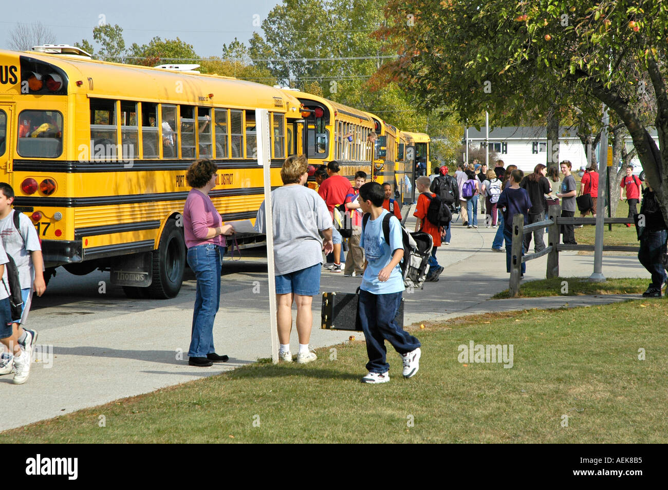 School busses in line to pick up students at the end of the school ...