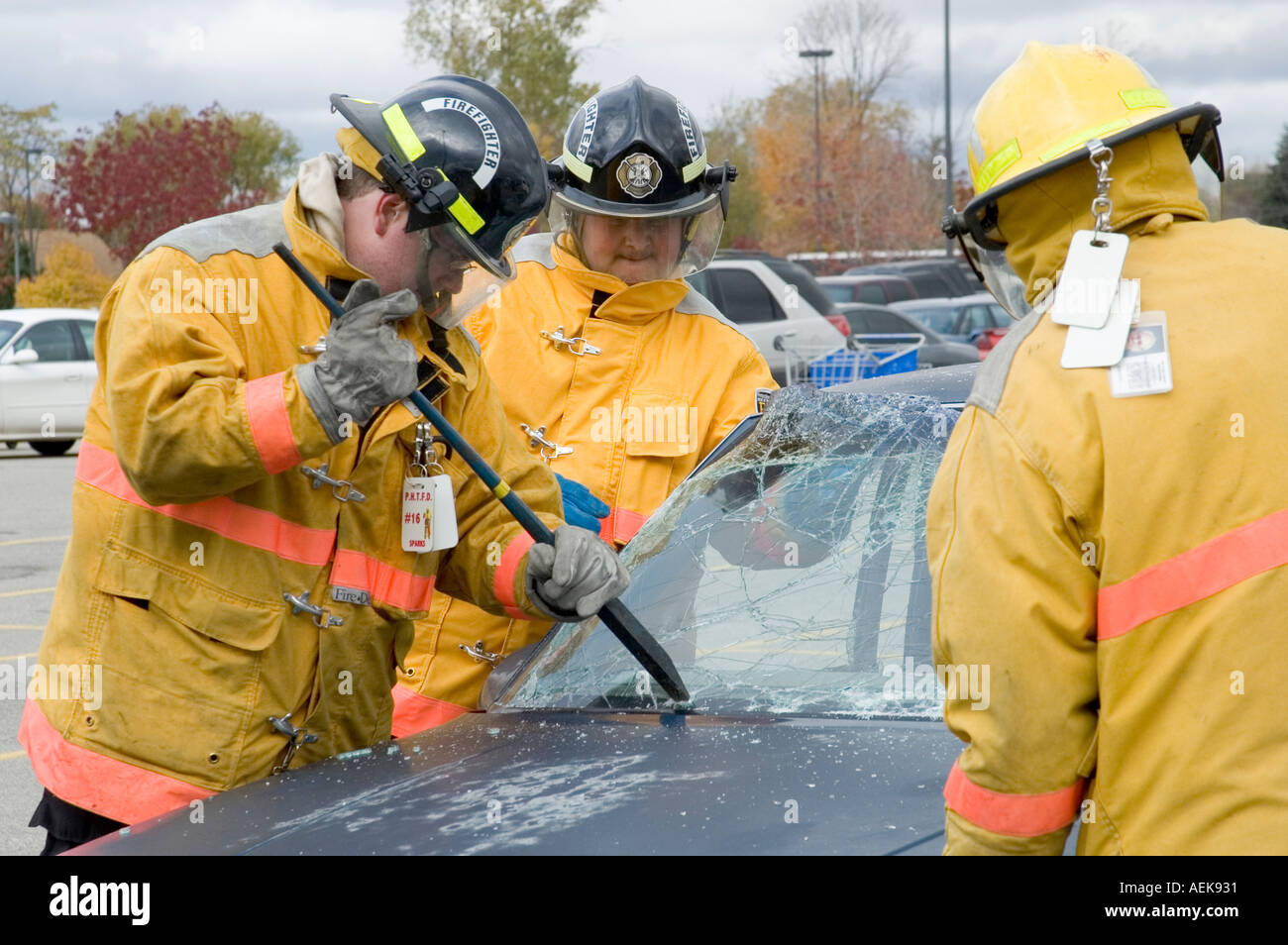 Fireman works with the jaws of life to extract victim from automobile ...