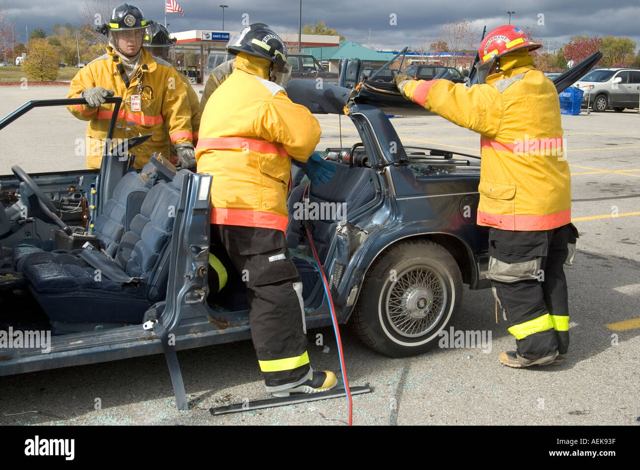Fireman works with the jaws of life to extract victim from automobile ...