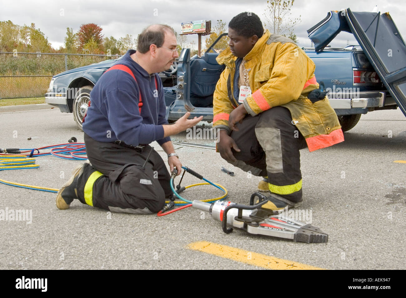 Two firemen train on the use of the jaws of life equipment for use with ...