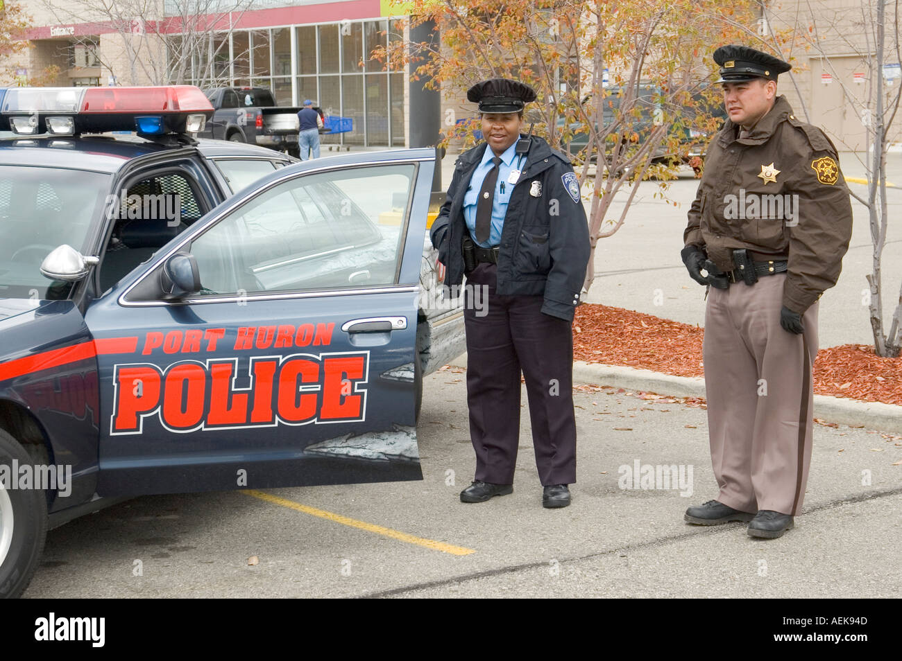 Sheriff deputy and black female city police officer work together at an ...