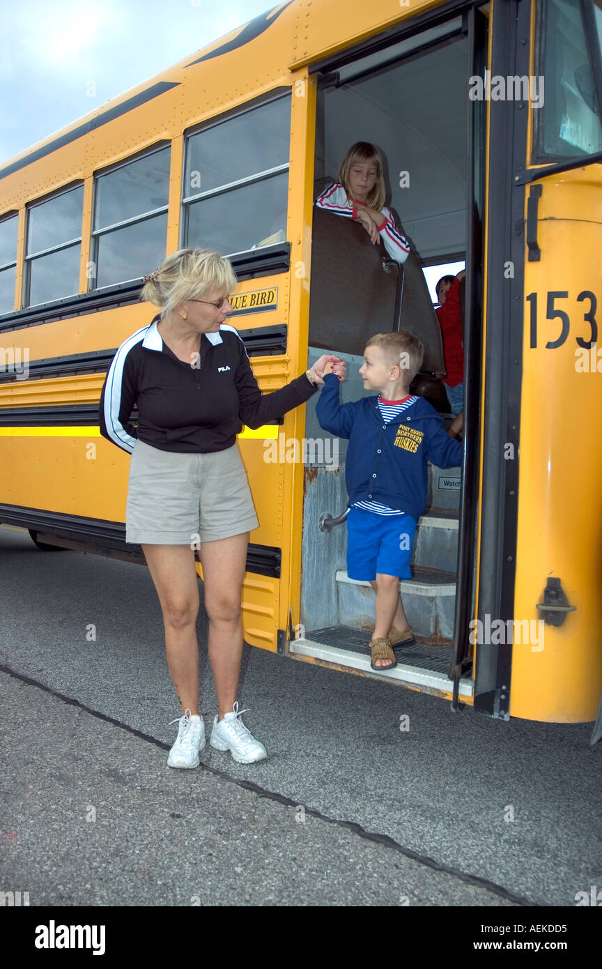 Bus driver helps a small student get off a school bus Stock Photo - Alamy