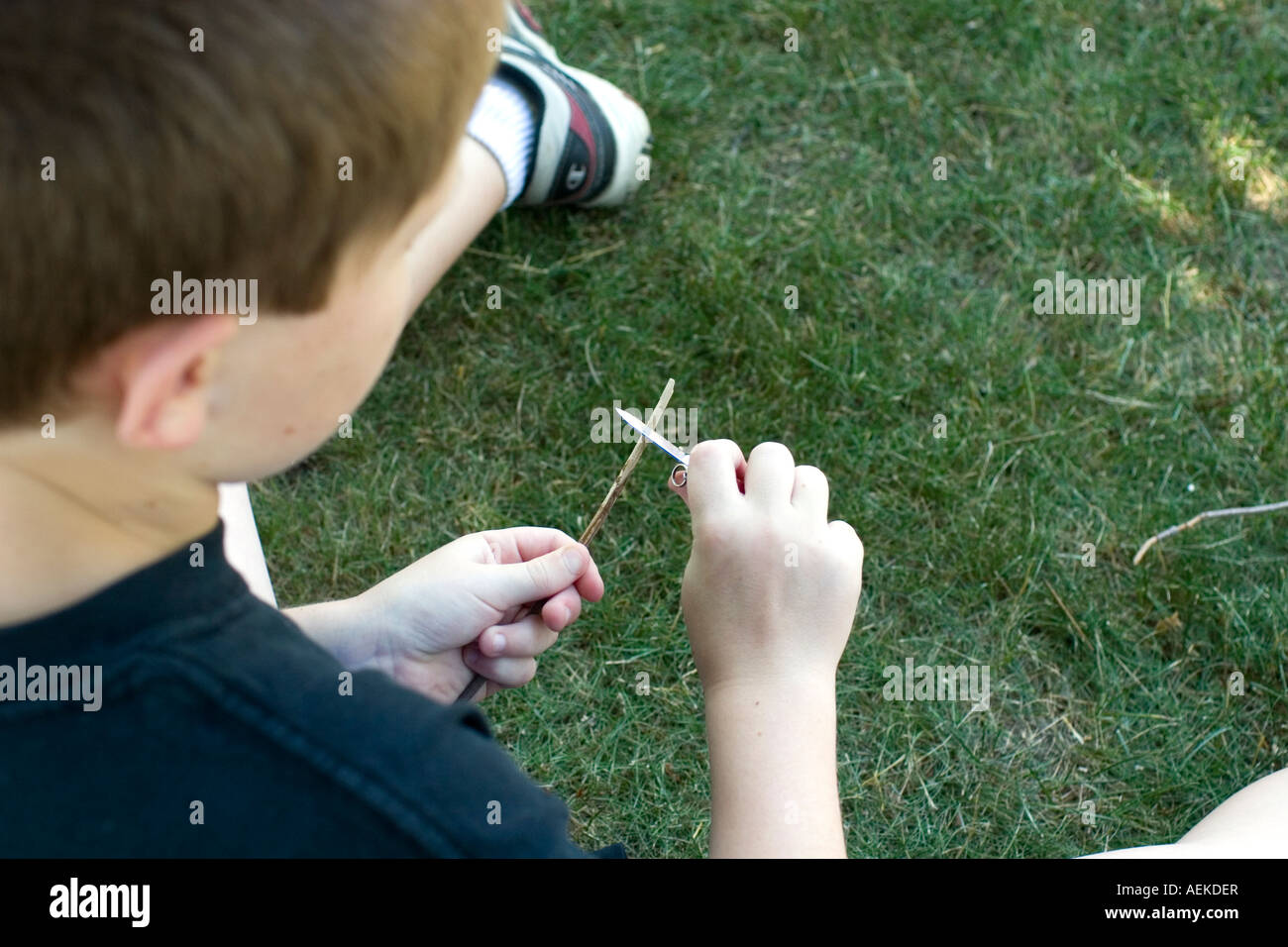 Young Boy Widdling with Pocket Knife Stock Photo - Alamy