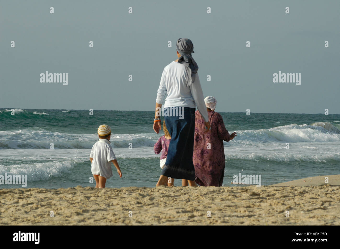 Religious Jewish settlers walk with their siblings along the ...
