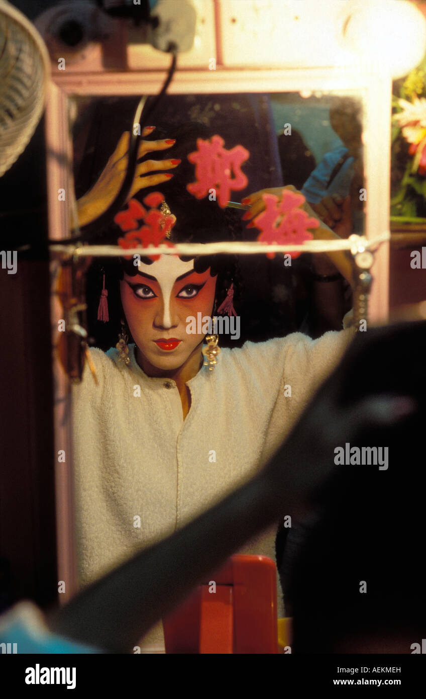 Chinese Opera Singer adjusting makeup backstage at a performance in ...