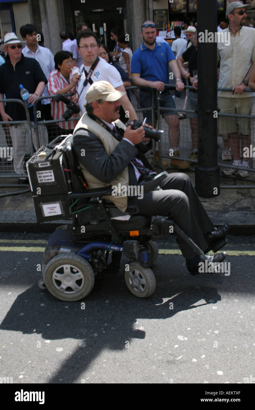 Disabled White male photographer in a wheelchair photographing Euro ...