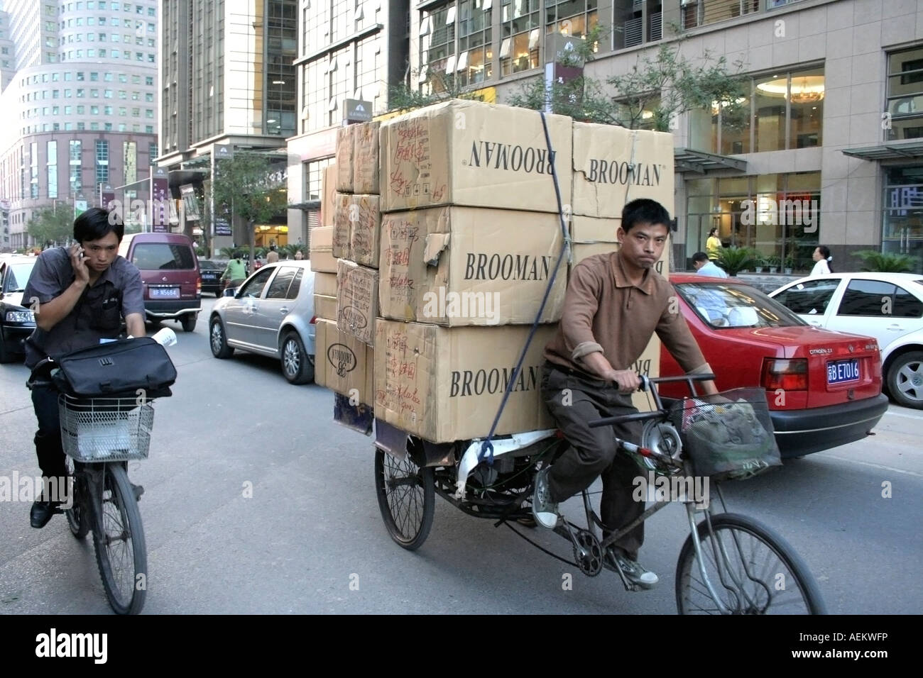 Rising China - Cyclist with handphone and traditional pedicab against ...