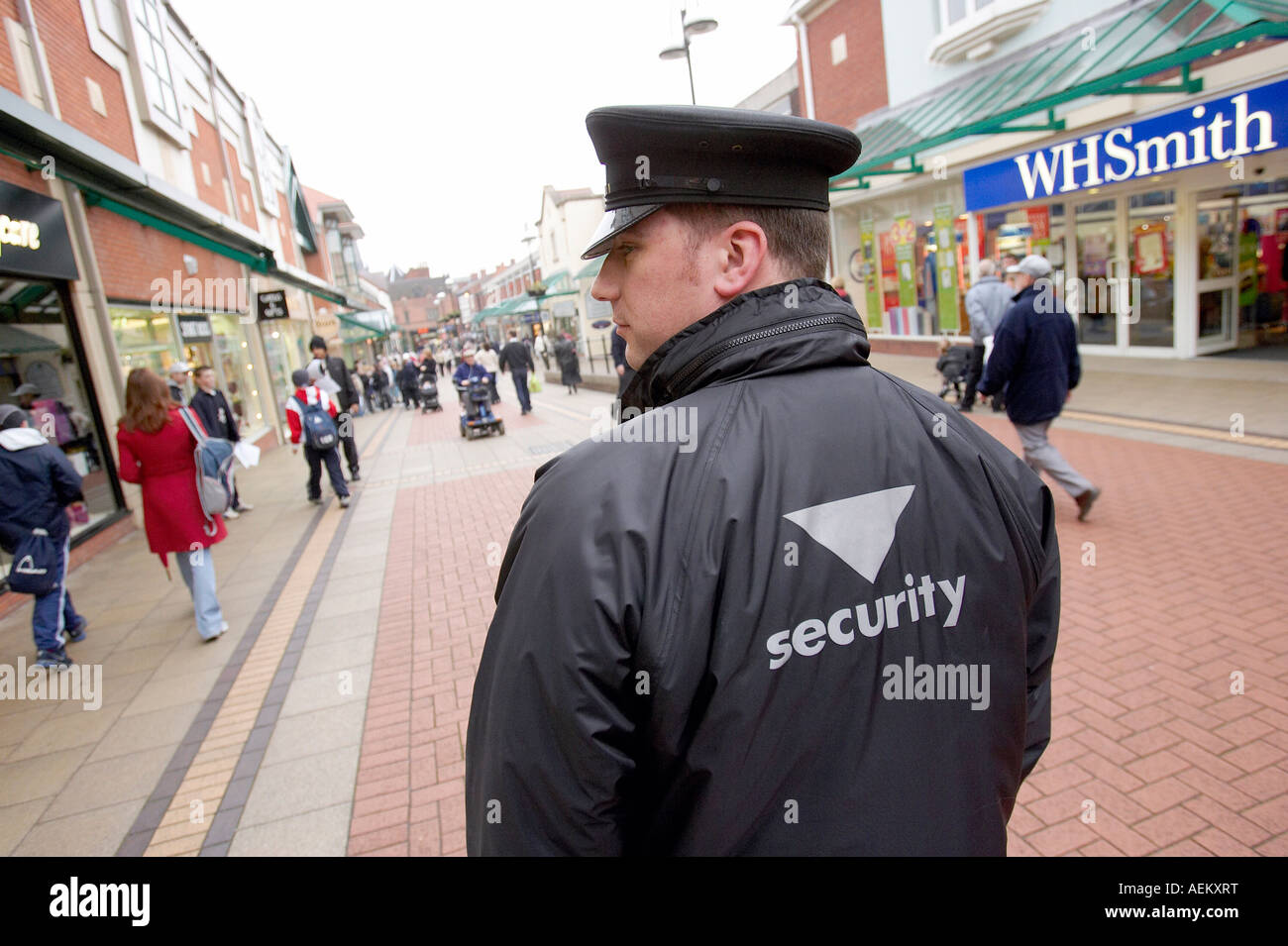 A security guard watches shoppers in Lichfield town centre Stock Photo ...