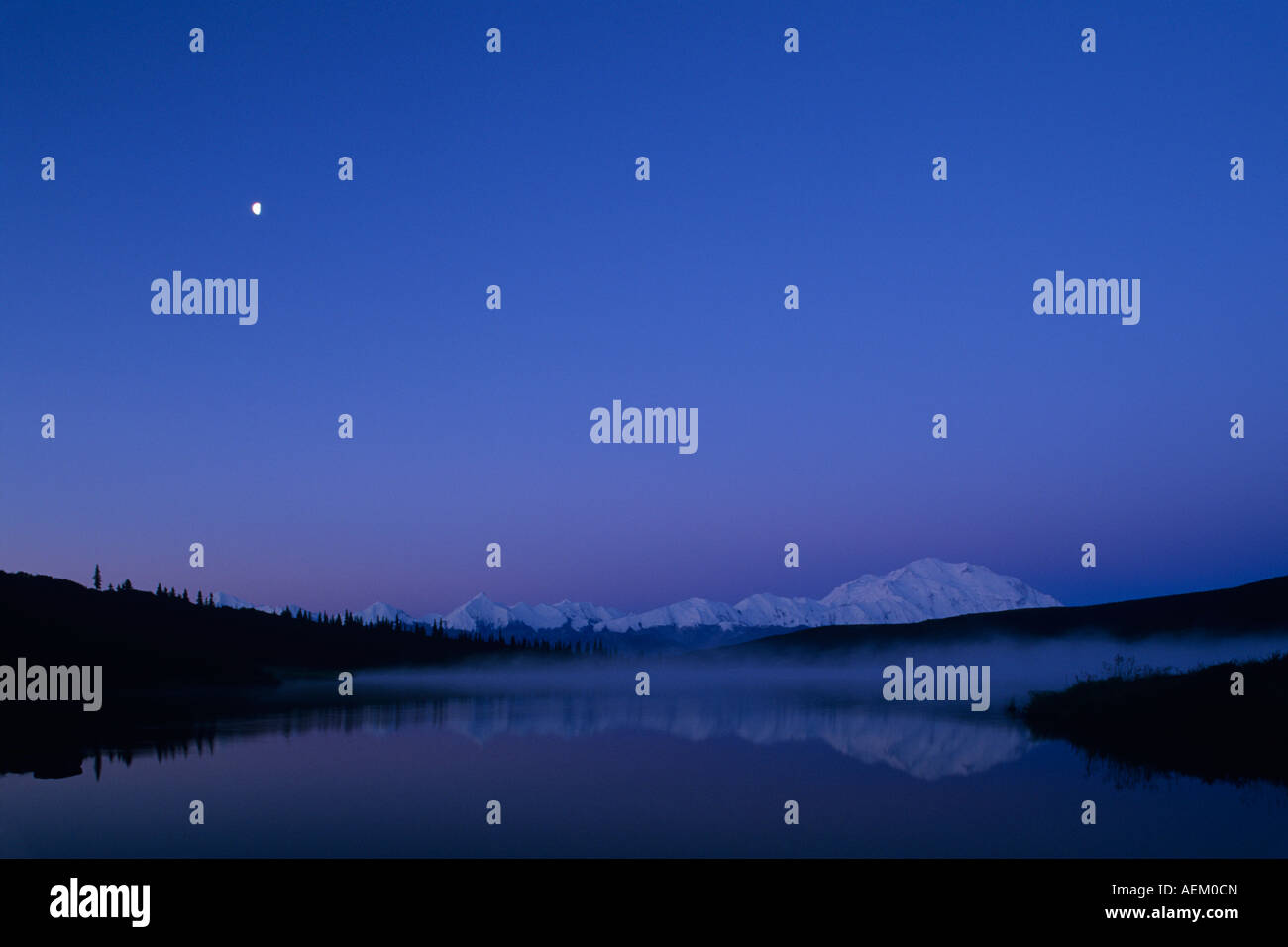 USA Alaska Denali National Park Gibbous moon above Mount McKinley and ...