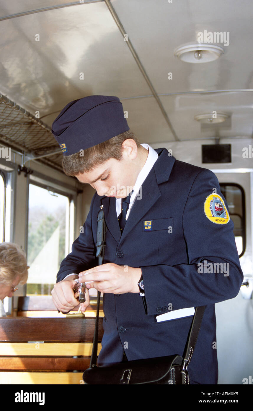 Children’s Railway (Gyermek Vasut), boy conductor clipping ticket ...