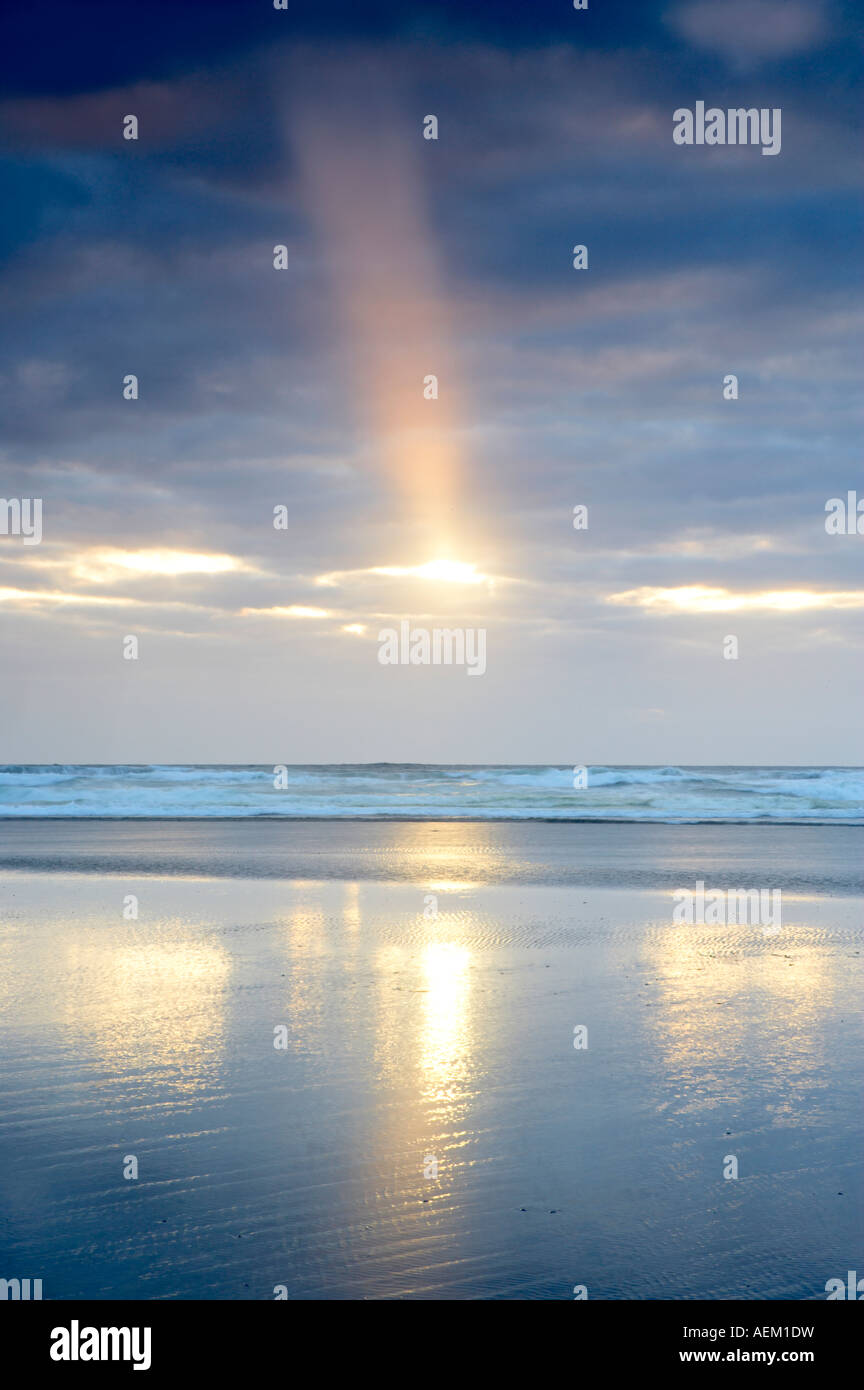 Low tide reflection with sunburst Rockaway Beach Oregon Stock Photo - Alamy