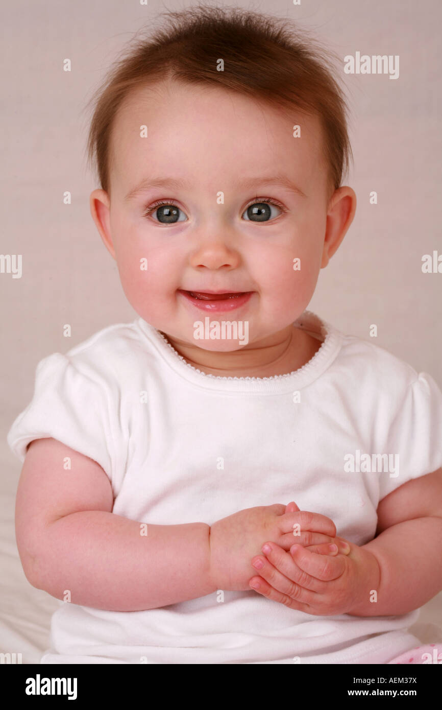 Gorgeous cute newborn baby at 7 seven months sitting up holding hands ...