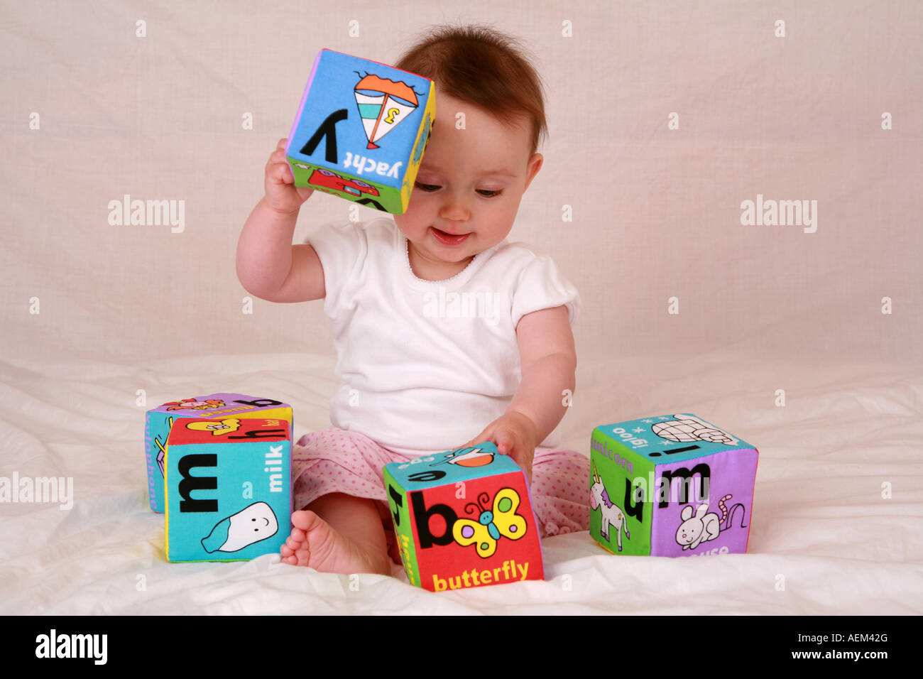Gorgeous cute newborn baby sitting and playing with alphabet letter ...