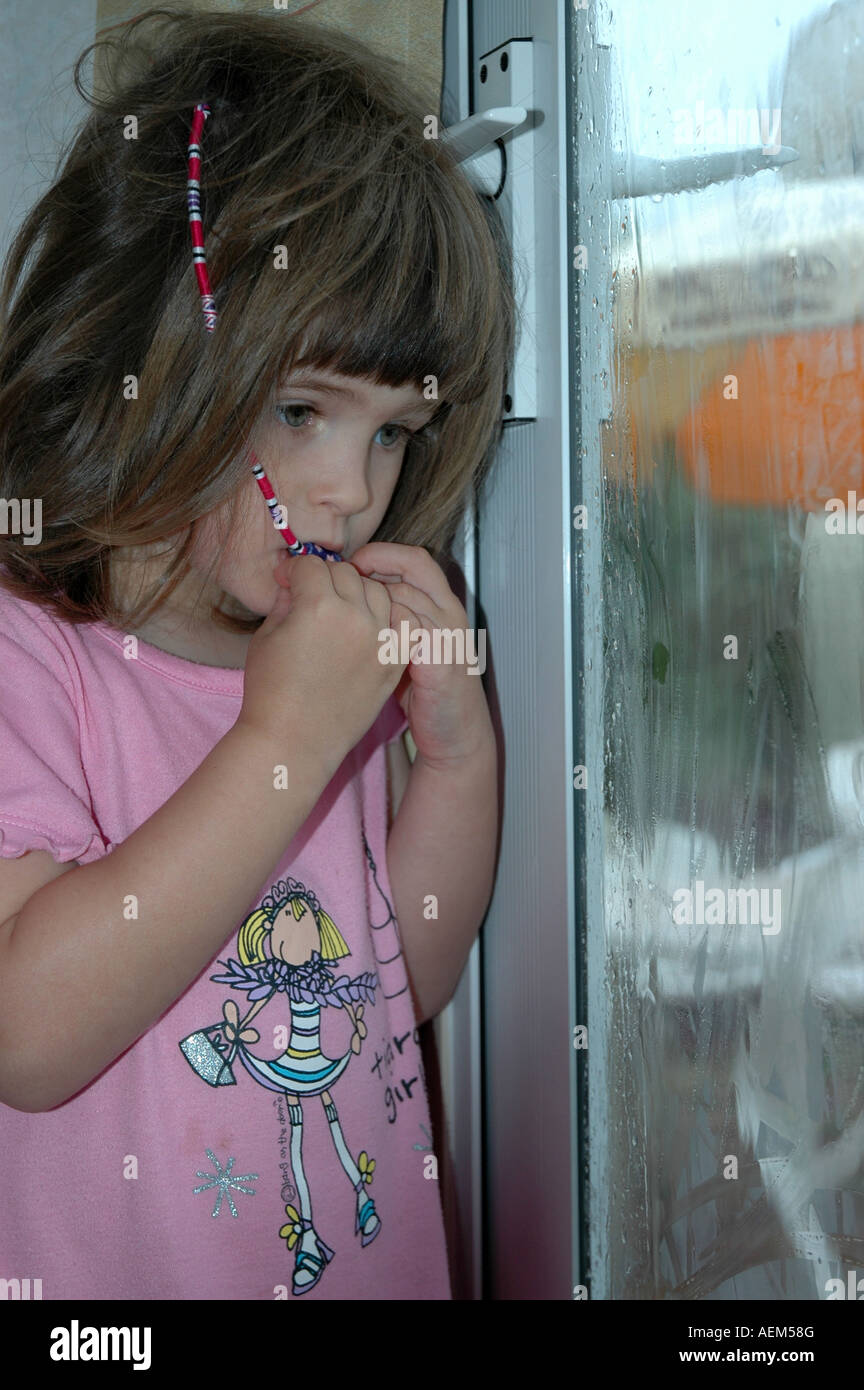 Small Girl Watching Rain Through Caravan Window Stock Photo - Alamy