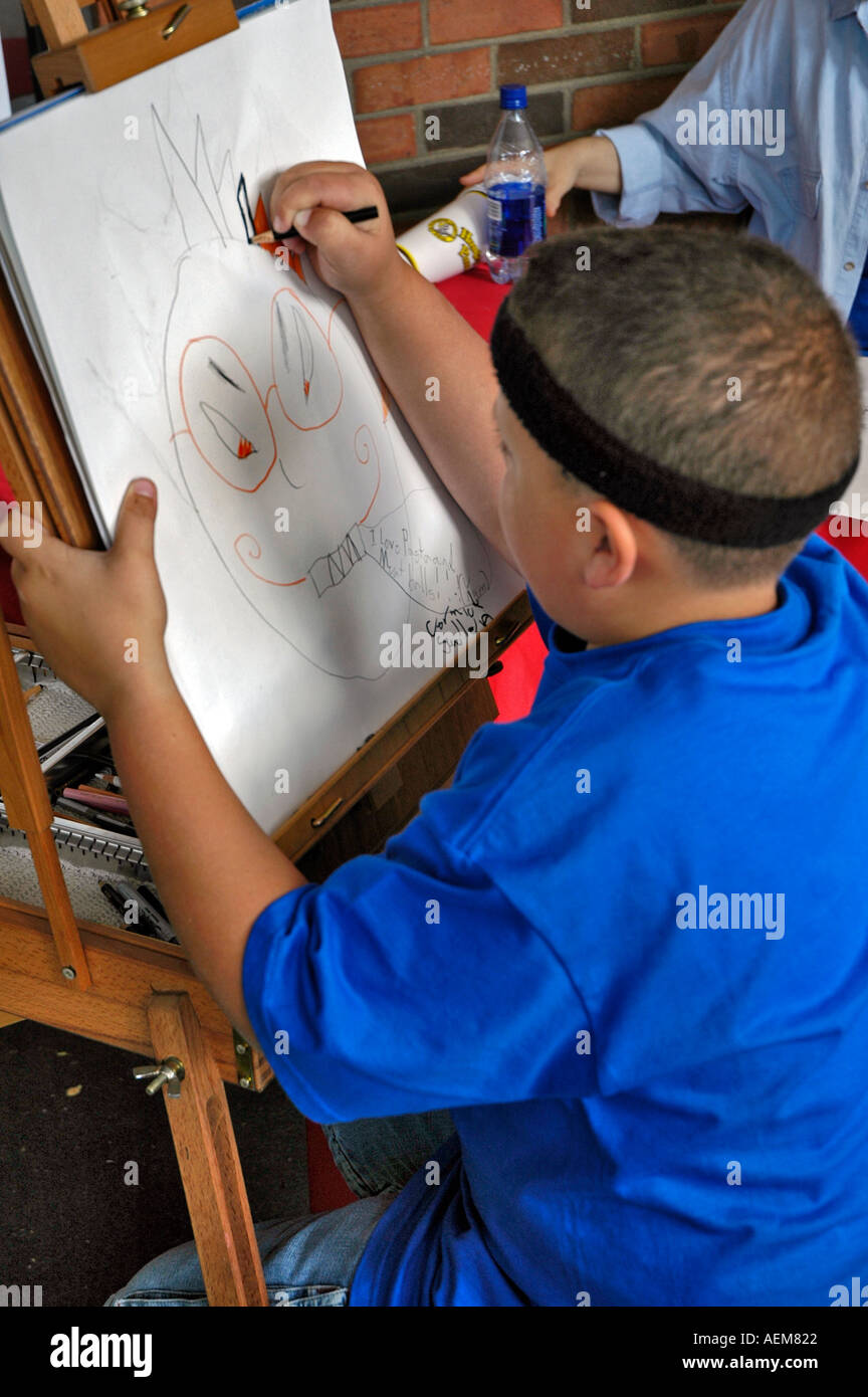 Black minority boy draws a picture of a cartoon character Stock Photo ...