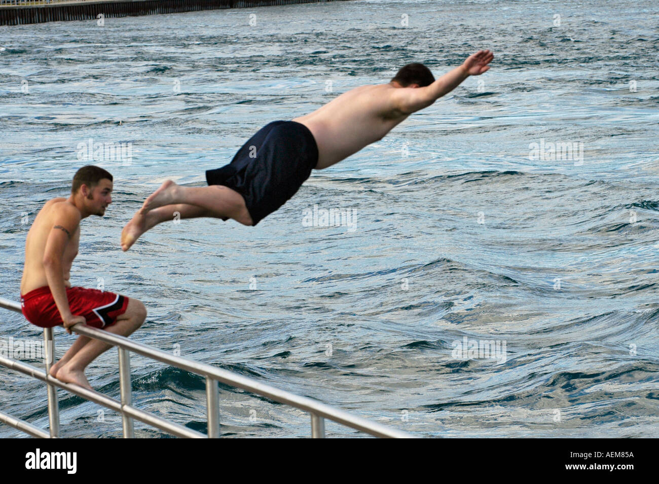 Teenage boy dives into the water Stock Photo - Alamy