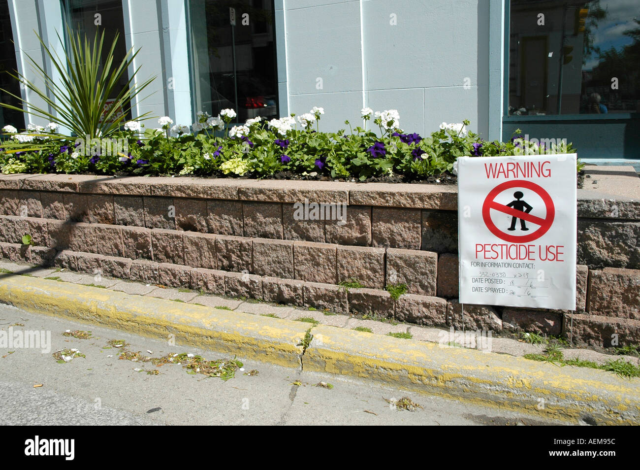 Sign in a public flower bed warning that pesticide has just been used ...