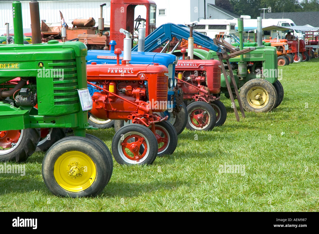 Local farmers display old farm tractors in a circa 1920 saw mill ...