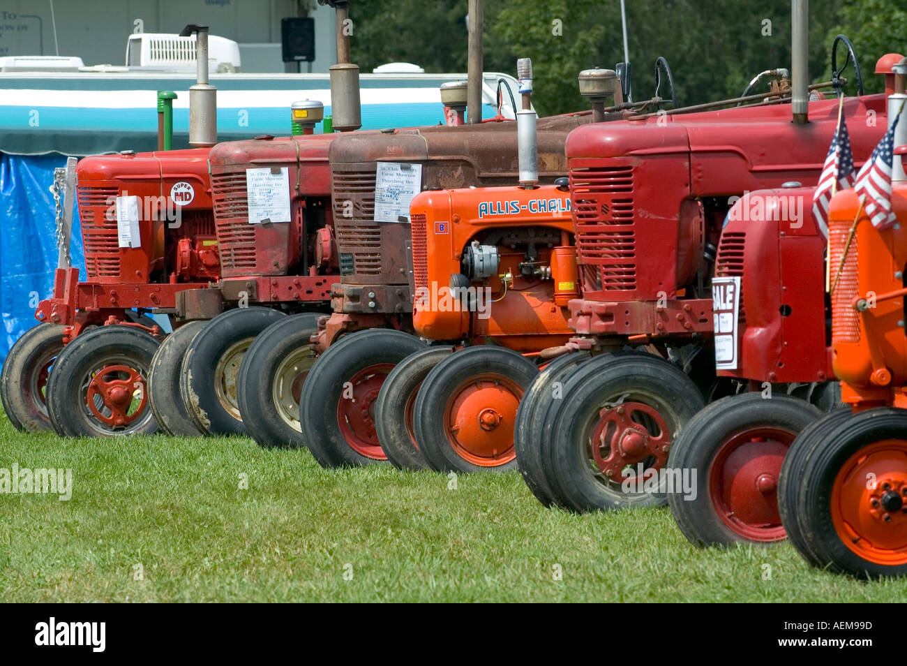 Local farmers display old farm tractors in a circa 1920 saw mill ...