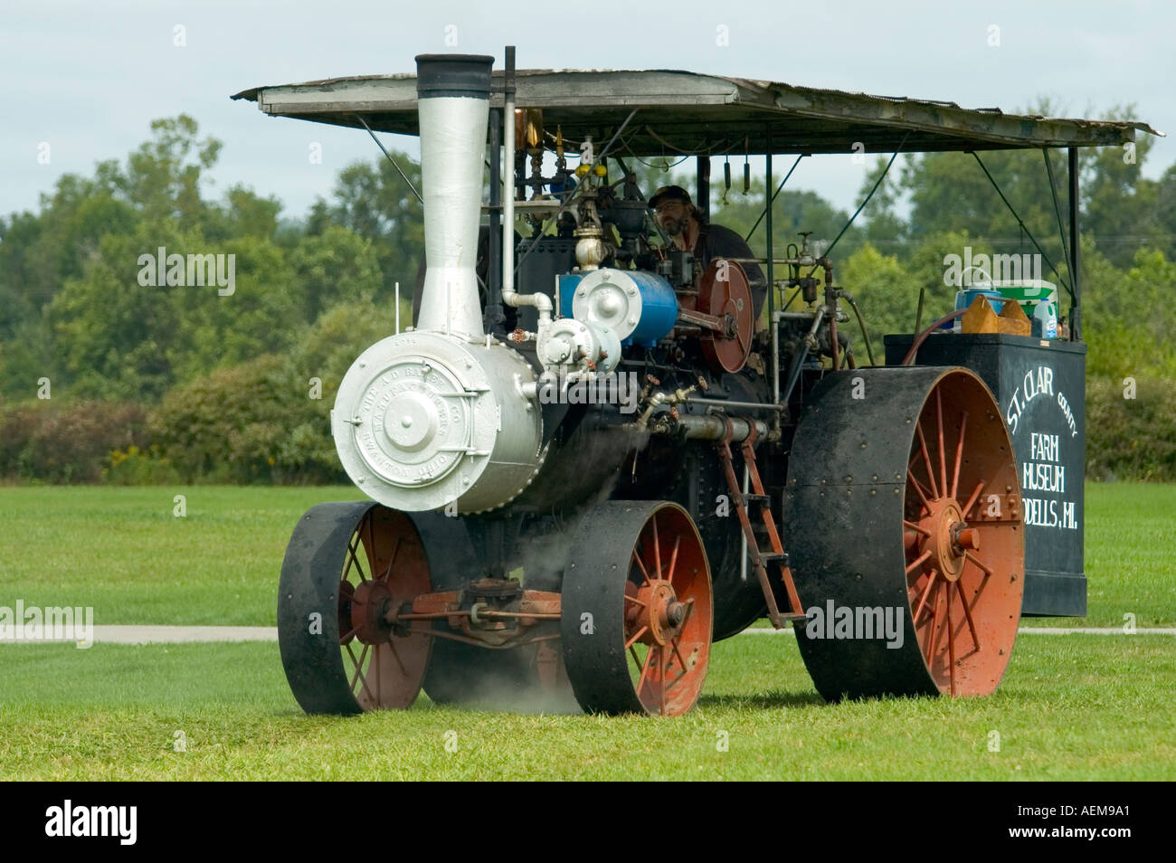 Local farmers display old farm tractors in a circa 1920 saw mill ...
