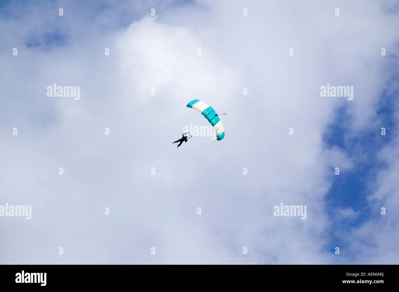 acrobatic parachutist blue jump suit green parachute Stock Photo - Alamy