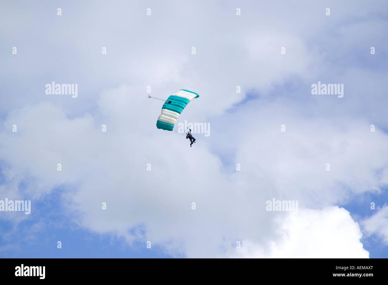 acrobatic parachutist blue jump suit green parachute Stock Photo - Alamy