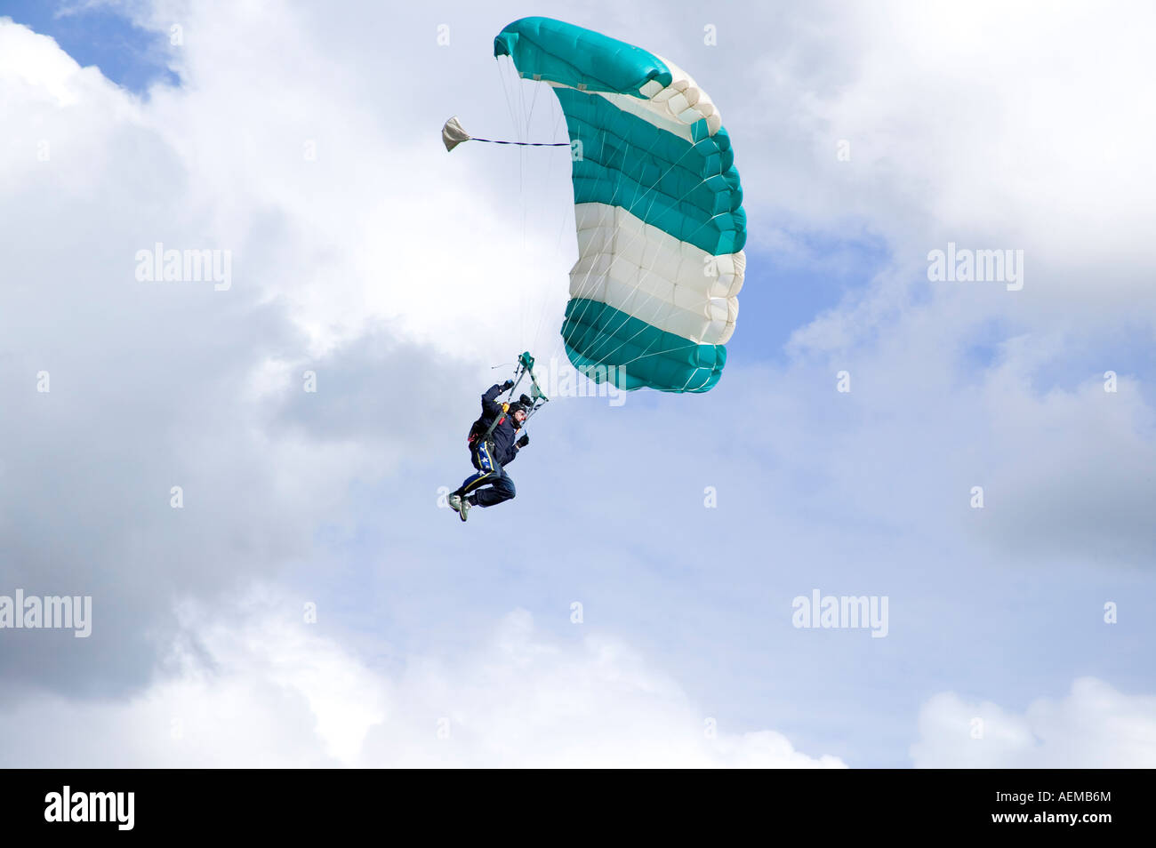 acrobatic parachutist blue jump suit green parachute Stock Photo - Alamy