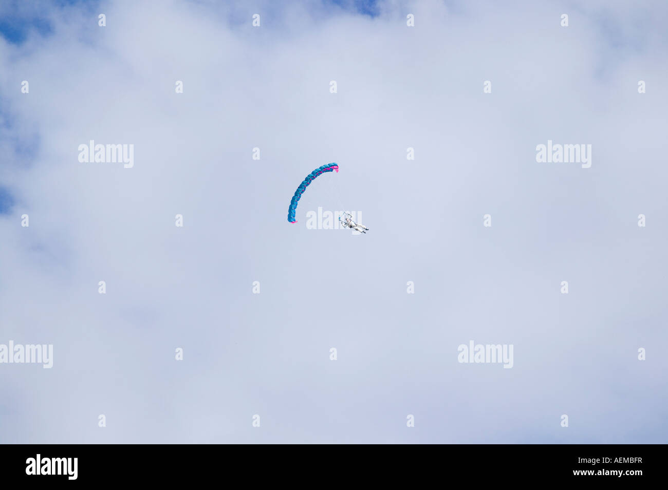 acrobatic parachutist white jump suit blue parachute Stock Photo - Alamy