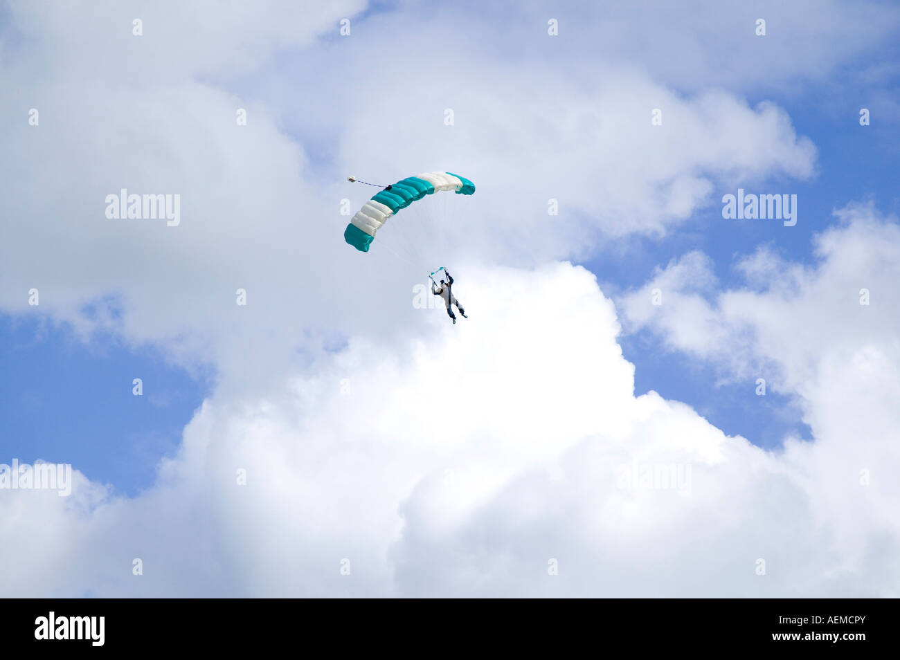 acrobatic parachutist blue jump suit green parachute Stock Photo - Alamy