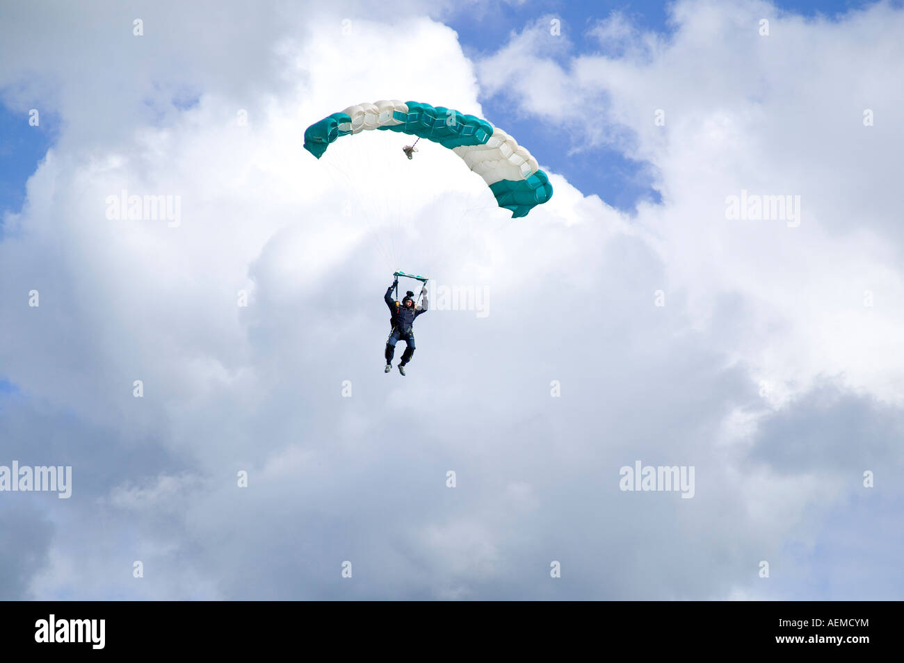 acrobatic parachutist blue jump suit green parachute Stock Photo - Alamy