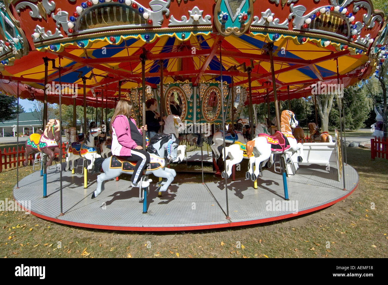 Children riding a merry go round Stock Photo - Alamy