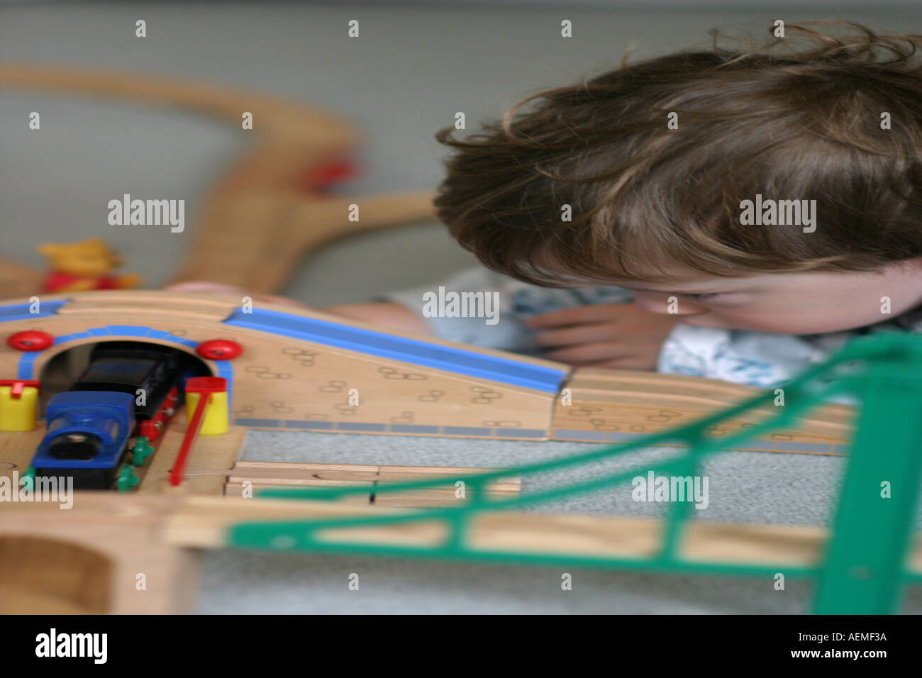 Lewis and his wooden train set Stock Photo - Alamy