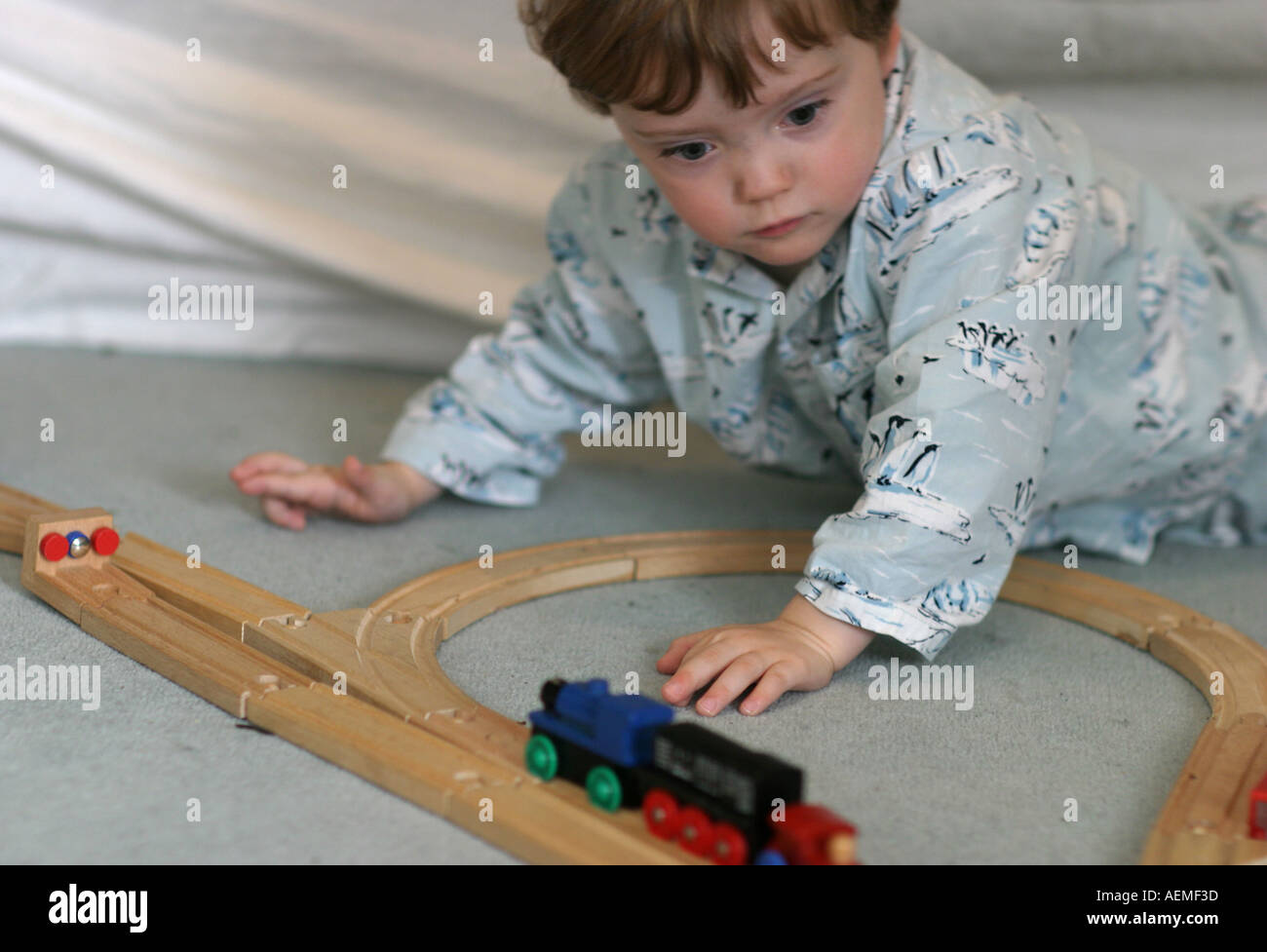 Lewis and his wooden train set Stock Photo - Alamy