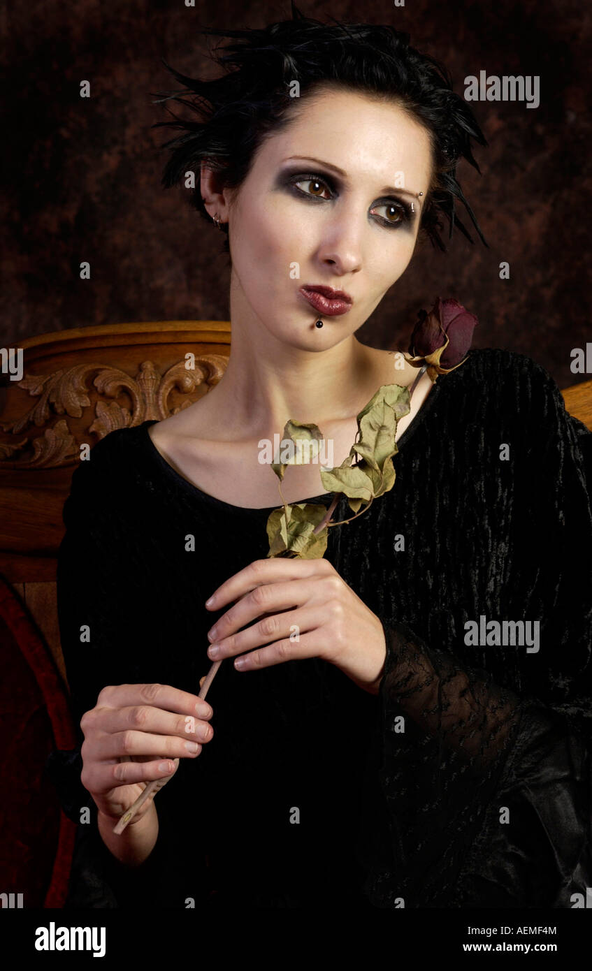 Portrait of a young Goth girl holding a dried rose Stock Photo - Alamy