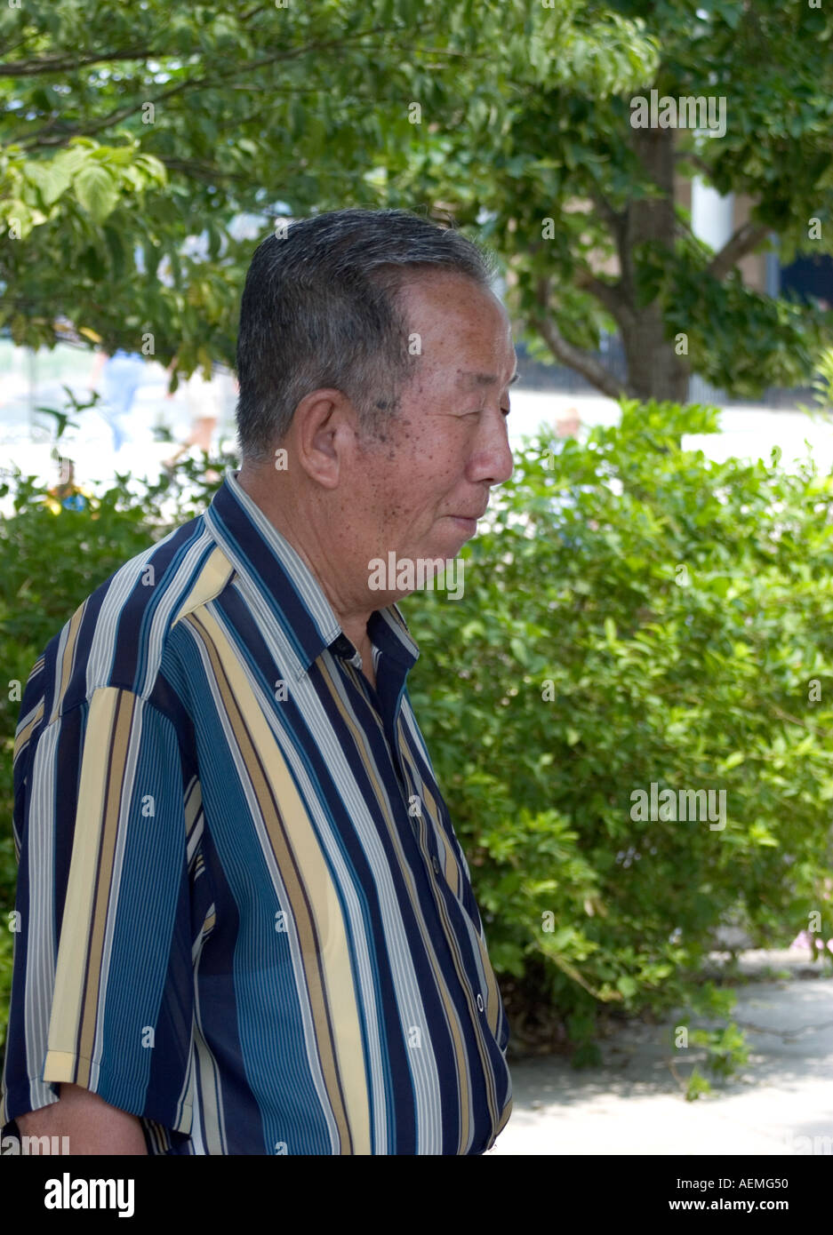 Chinese man walking outdoors Stock Photo - Alamy