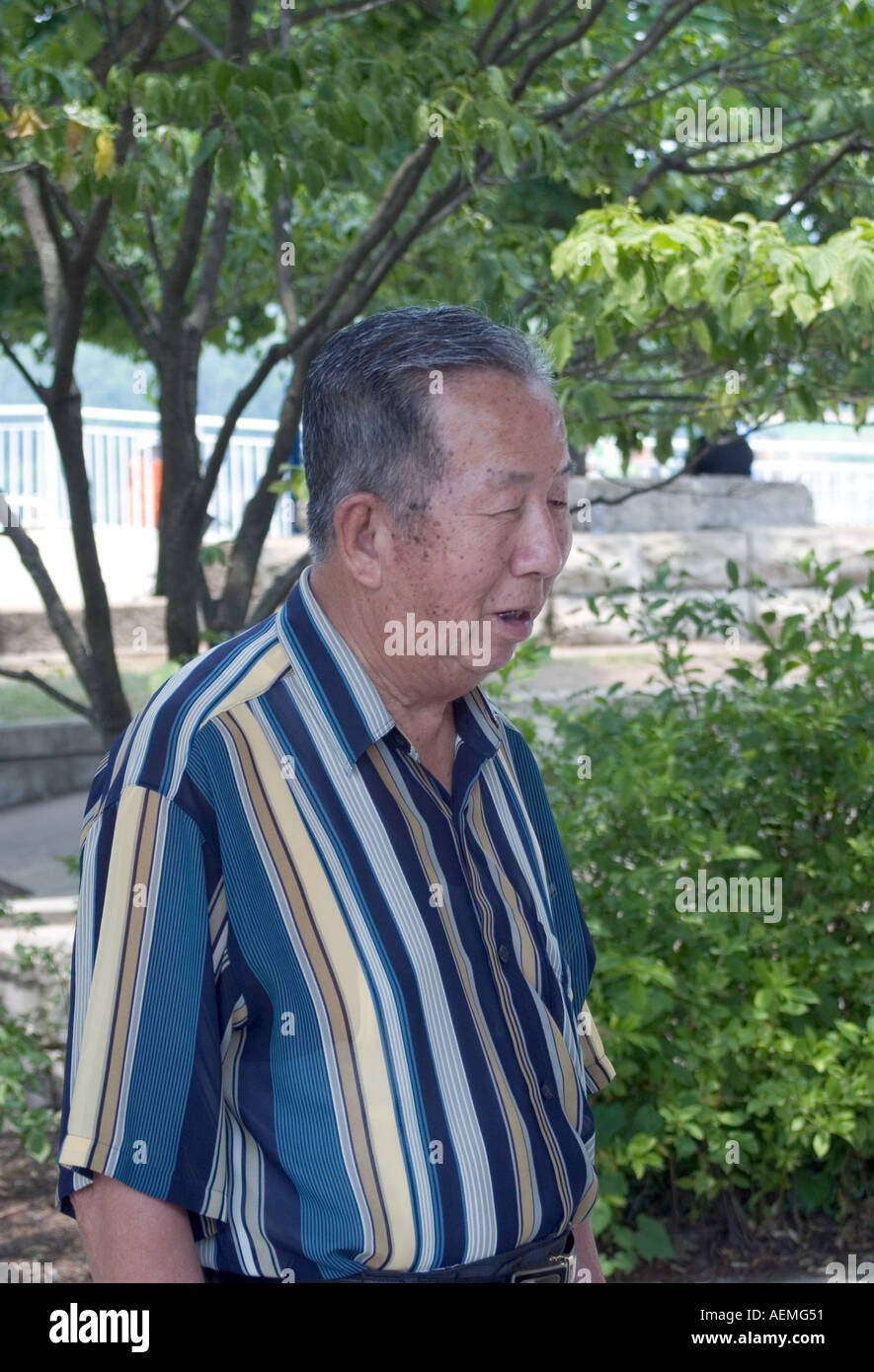Chinese man walking outdoors Stock Photo - Alamy