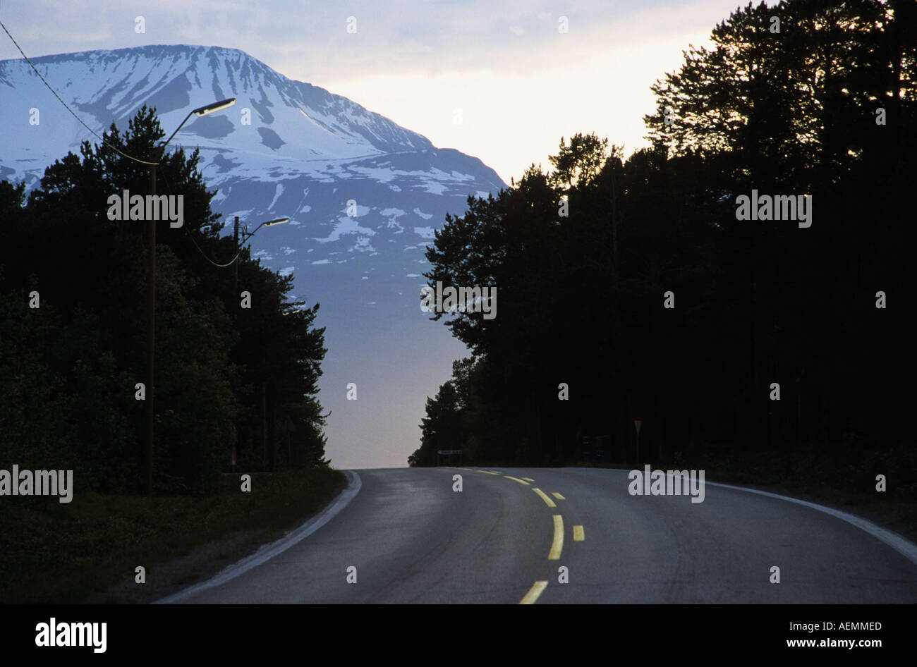 Road with mountains at dusk Stock Photo - Alamy