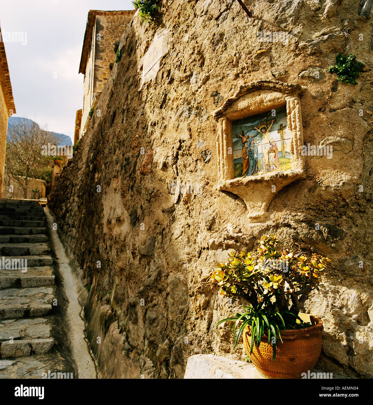 Steps in a rural street with religious icon, Deia, Mallorca Stock Photo ...