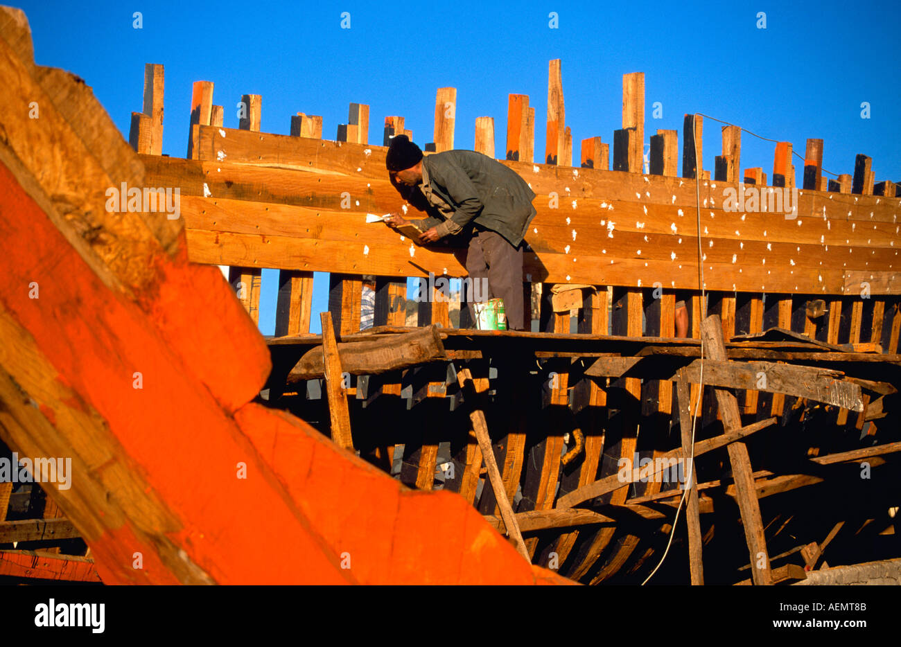 craftsman is painting a wooden boat fuselage in the harbour agadir ...