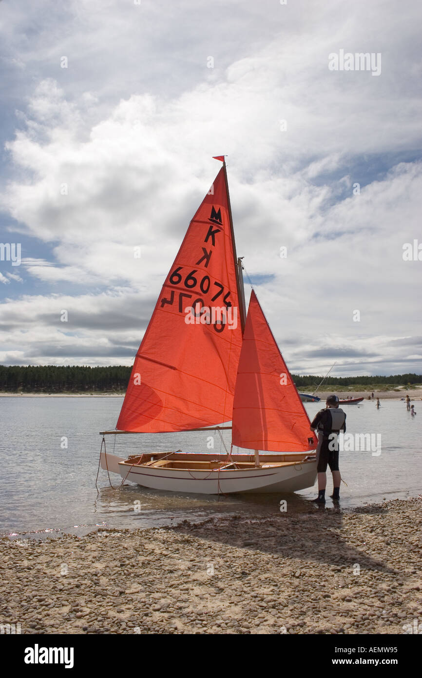 Sailing boats; Red sailing Dingy launched at Findhorn beach, North East ...