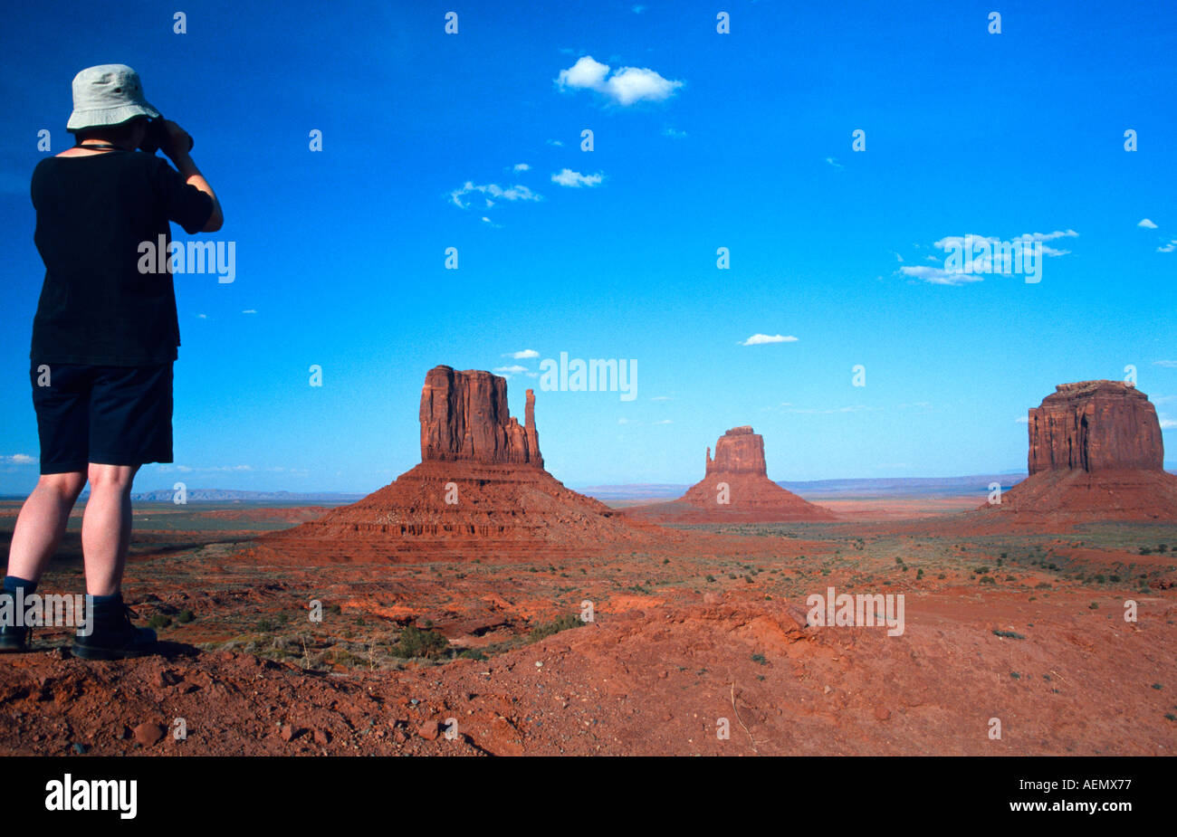 female tourist with binocular is looking at the monument valley ...