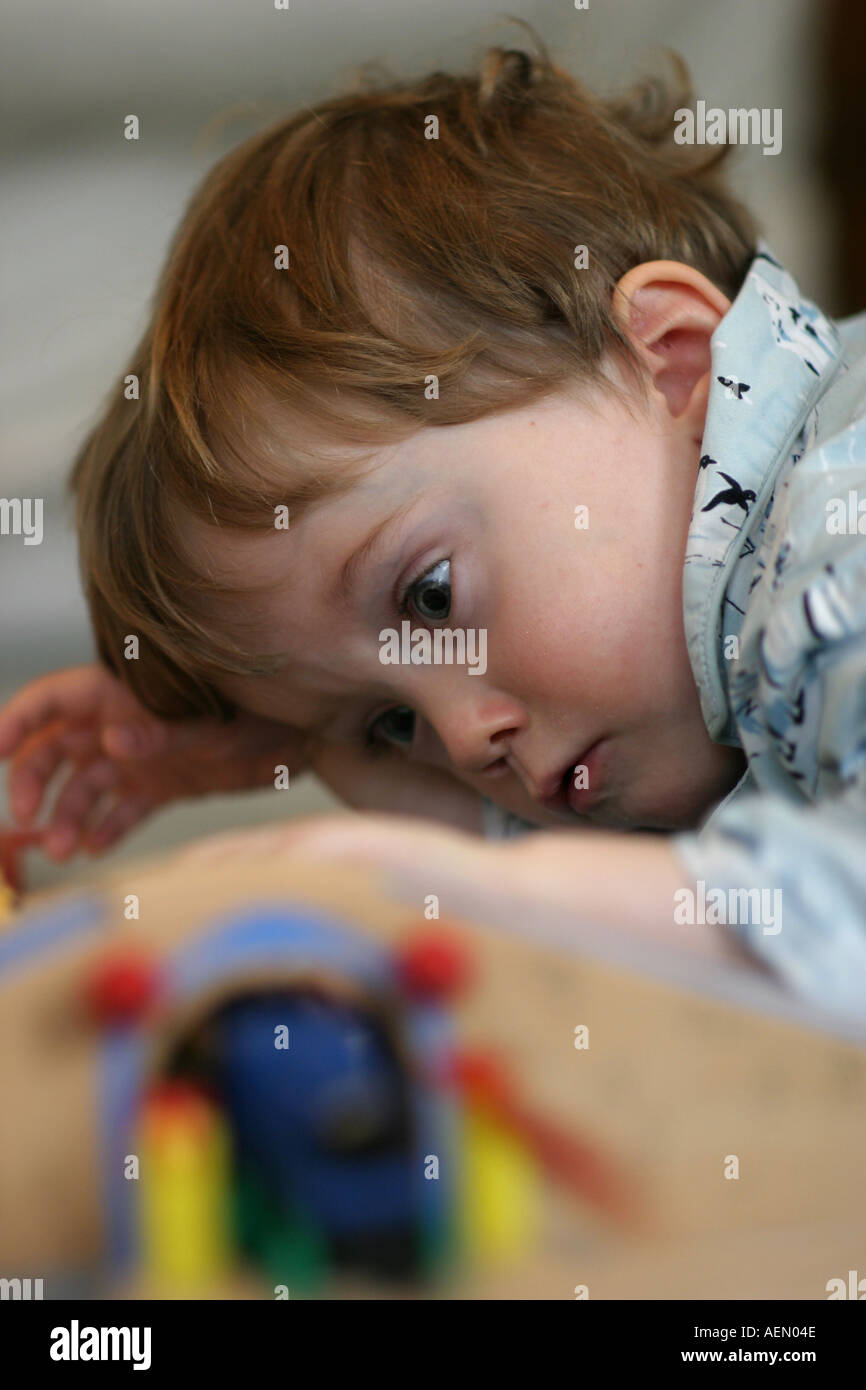 Lewis and his wooden train set Stock Photo - Alamy